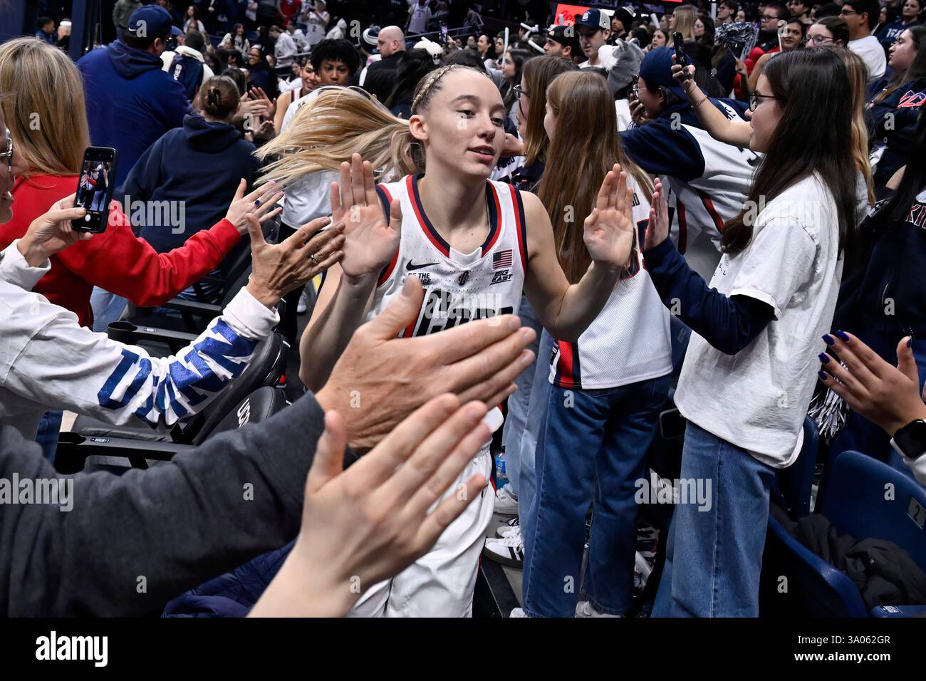 UConn guard Paige Bueckers slaps hands with the fans and the student ...