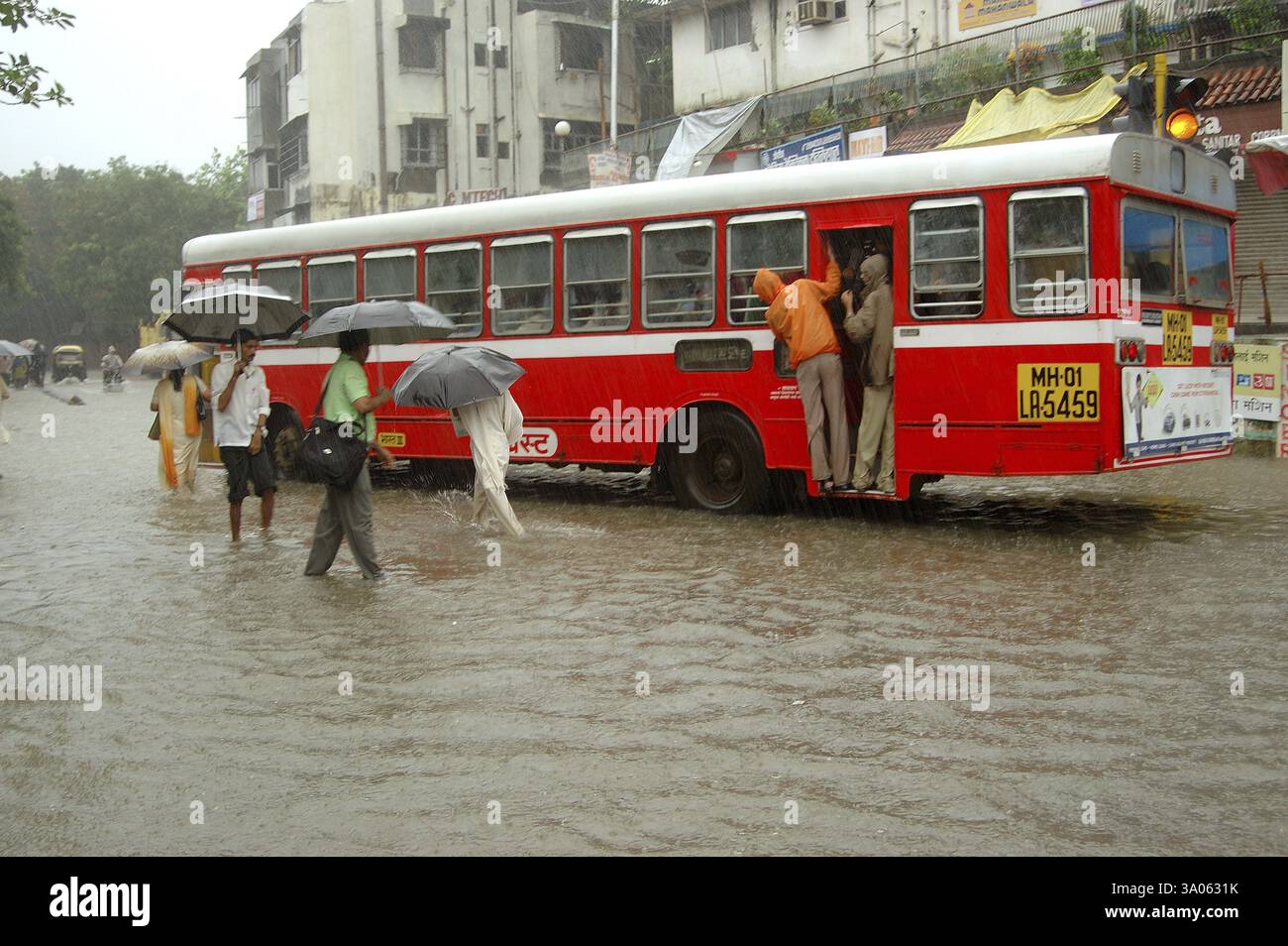People boarding bus in heavy rain on June 2006 at Bombay Mumbai ...