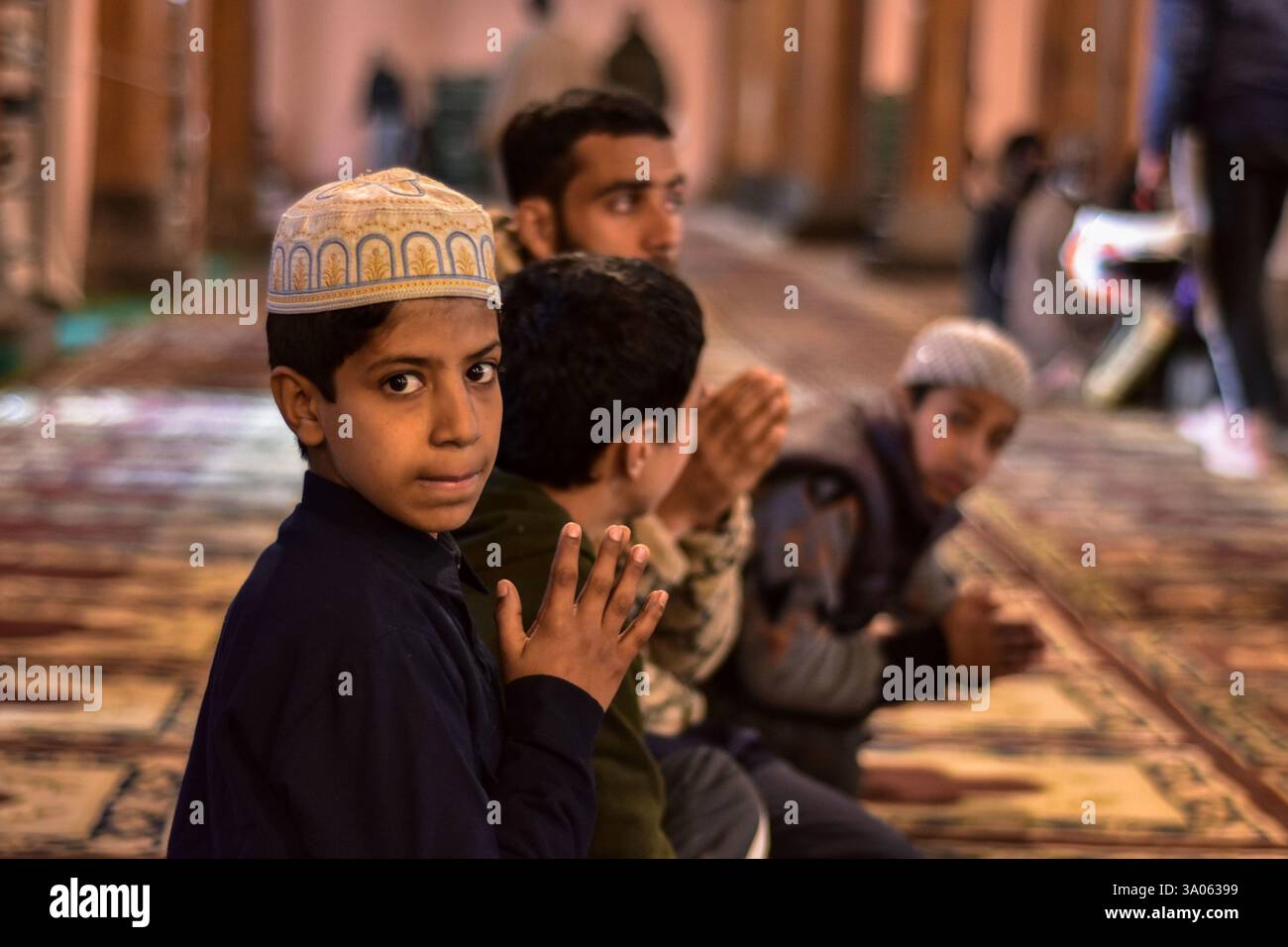 Srinagar, Kashmir, India. 2nd Mar, 2025. A Kashmiri Muslim boy looks on ...