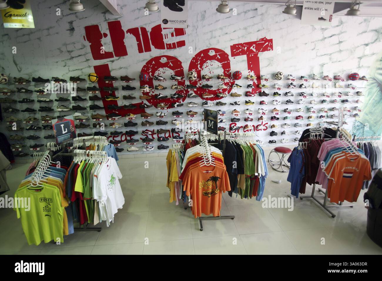 Shoes and T shirts kept on display at Loot store located in Andheri ...