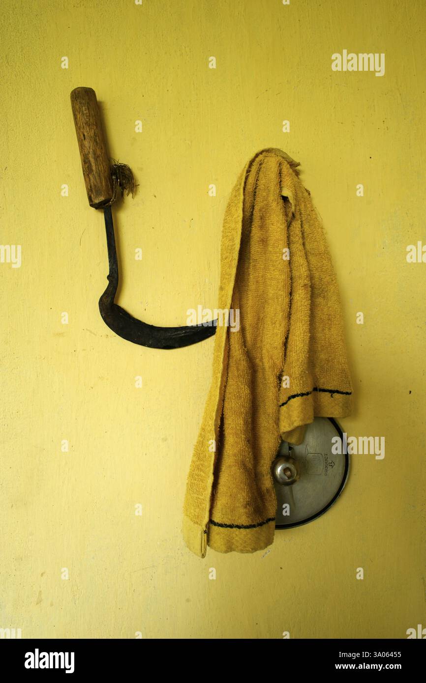 Sickle and clothes hanging on peg, Nepal, Asia Stock Photo - Alamy