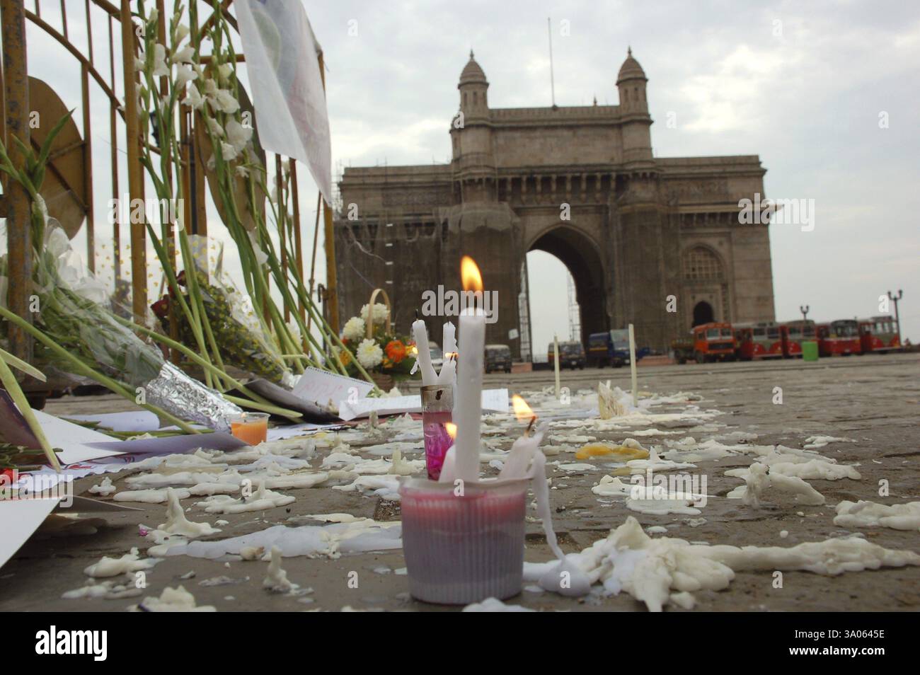 Flowers and candles in front of Gateway of India after terrorist attack ...