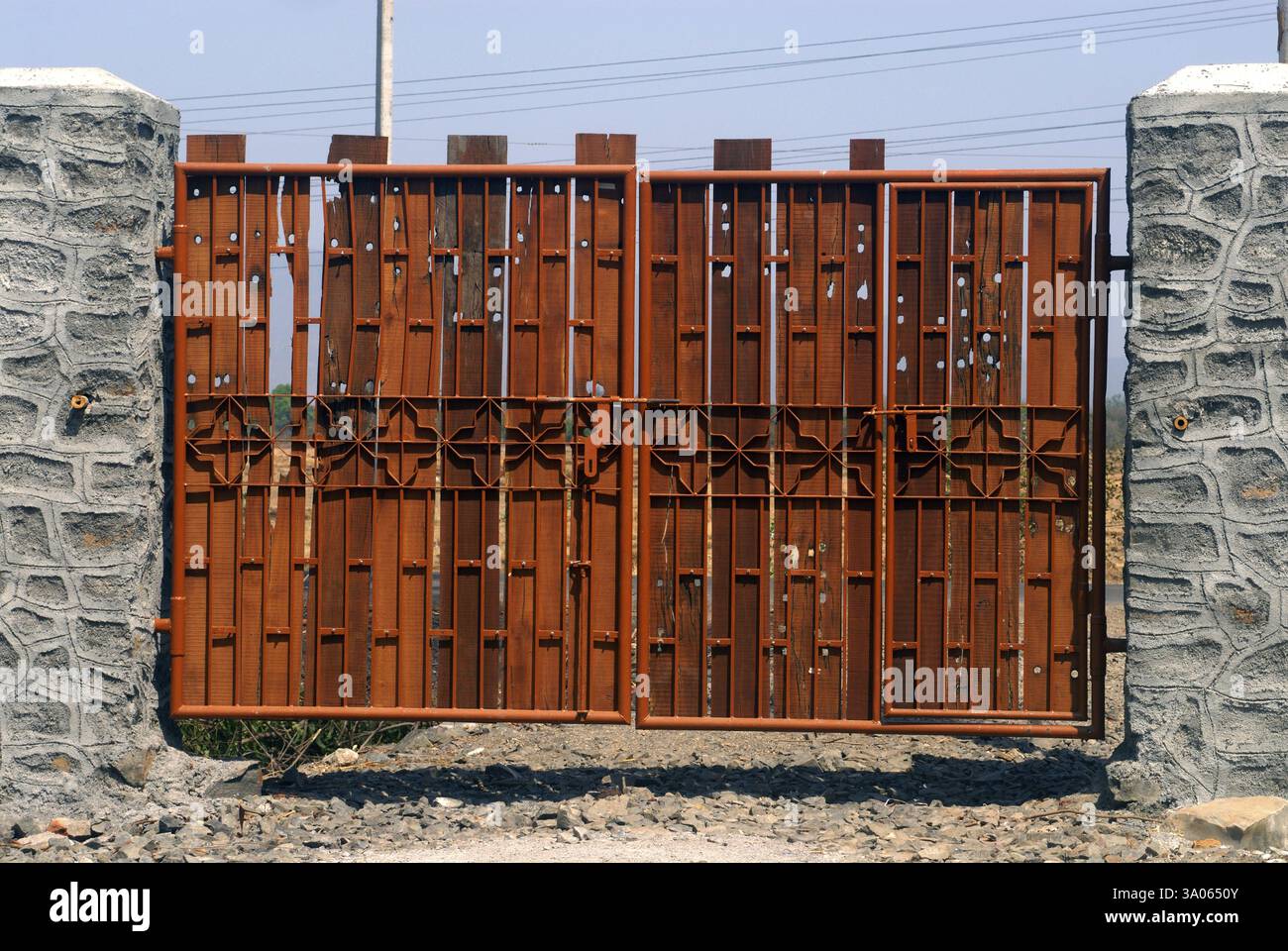 Mild steel pipe gate fixed in rubble masonry pillars, village Khadgoli ...