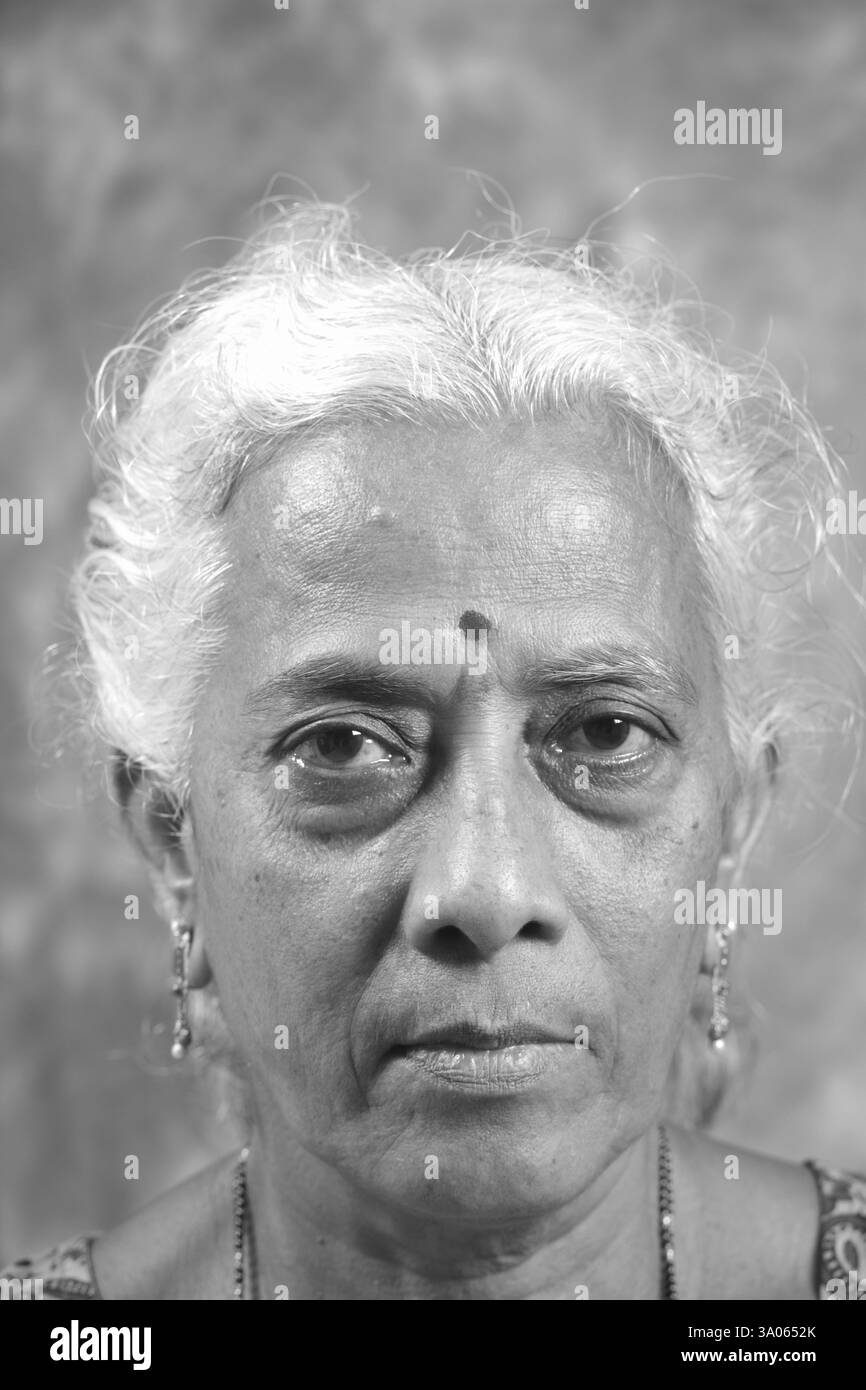 Elderly woman looks old photos Black and White Stock Photos & Images ...