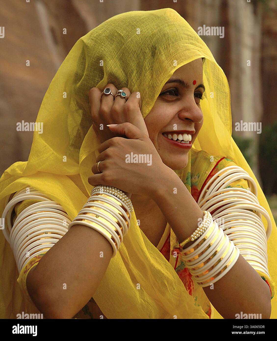 Rajasthani lady in yellow dress bangles in both hands, Jodhpur ...