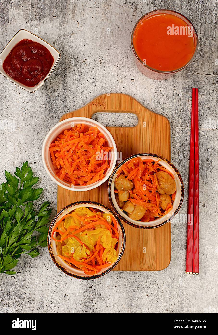 Carrot, cabbage, garlic, parsley and juice on concrete background ...