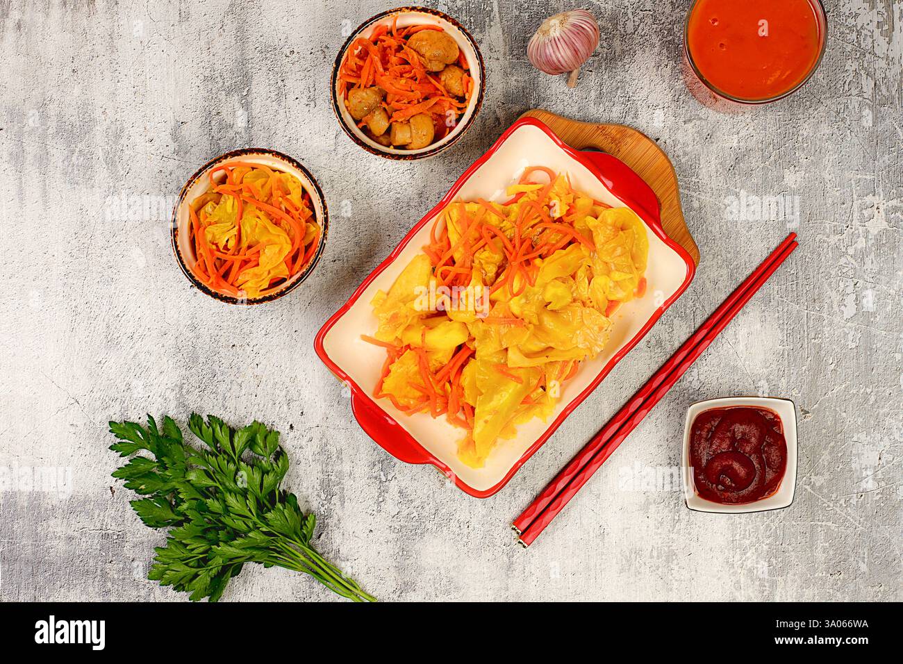 Carrot, cabbage, garlic, parsley and juice on concrete background ...