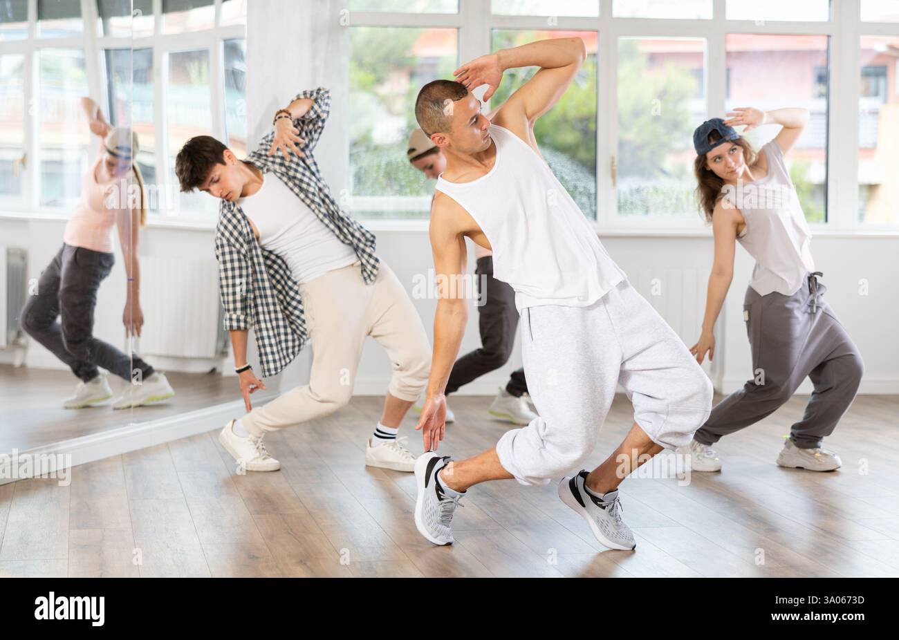 Young guy practicing breakdance in training hall Stock Photo - Alamy