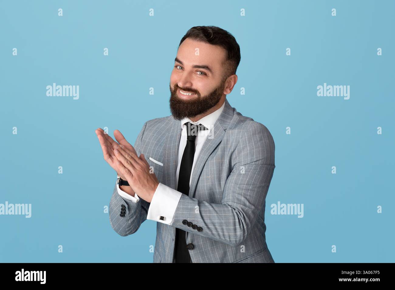 Portrait of happy young businessman giving applause, celebrating ...