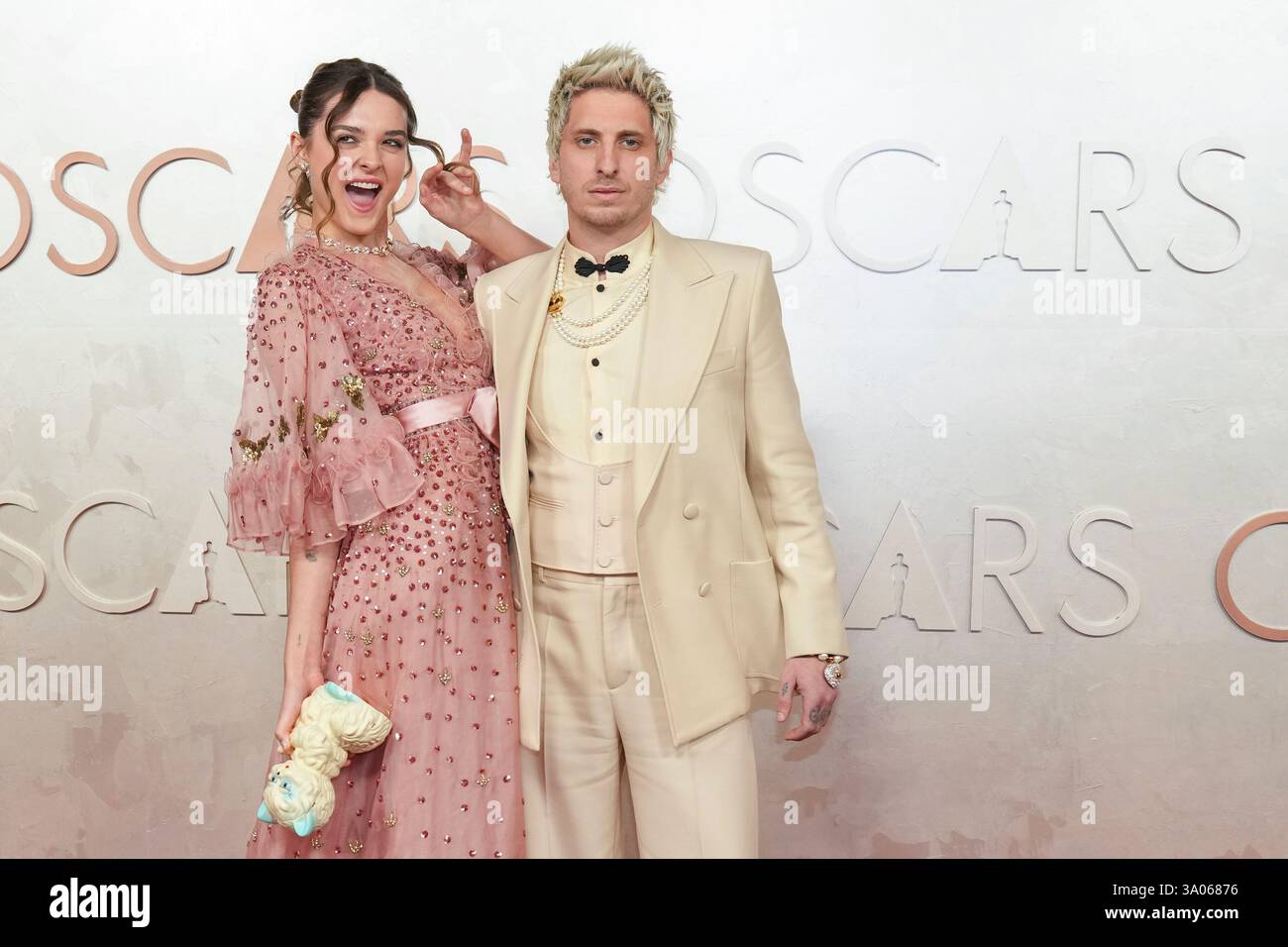 Charlotte Lawrence, left, and Andrew Watt arrive at the Oscars on Sunday, March 2, 2025, at the ...