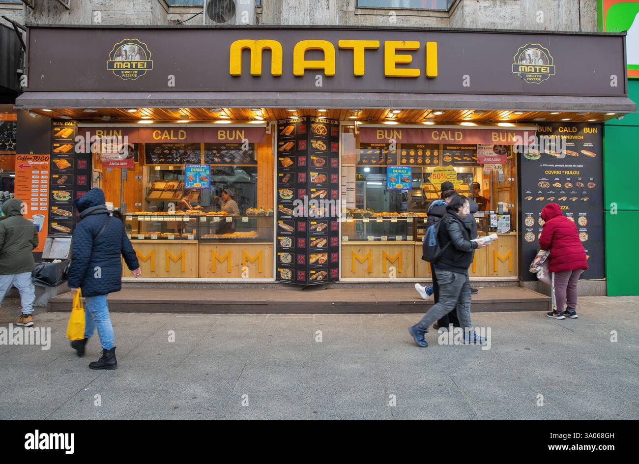 Bucharest, Romania - December 31, 2024: People visit fast food bakery shop chain Matei in ...