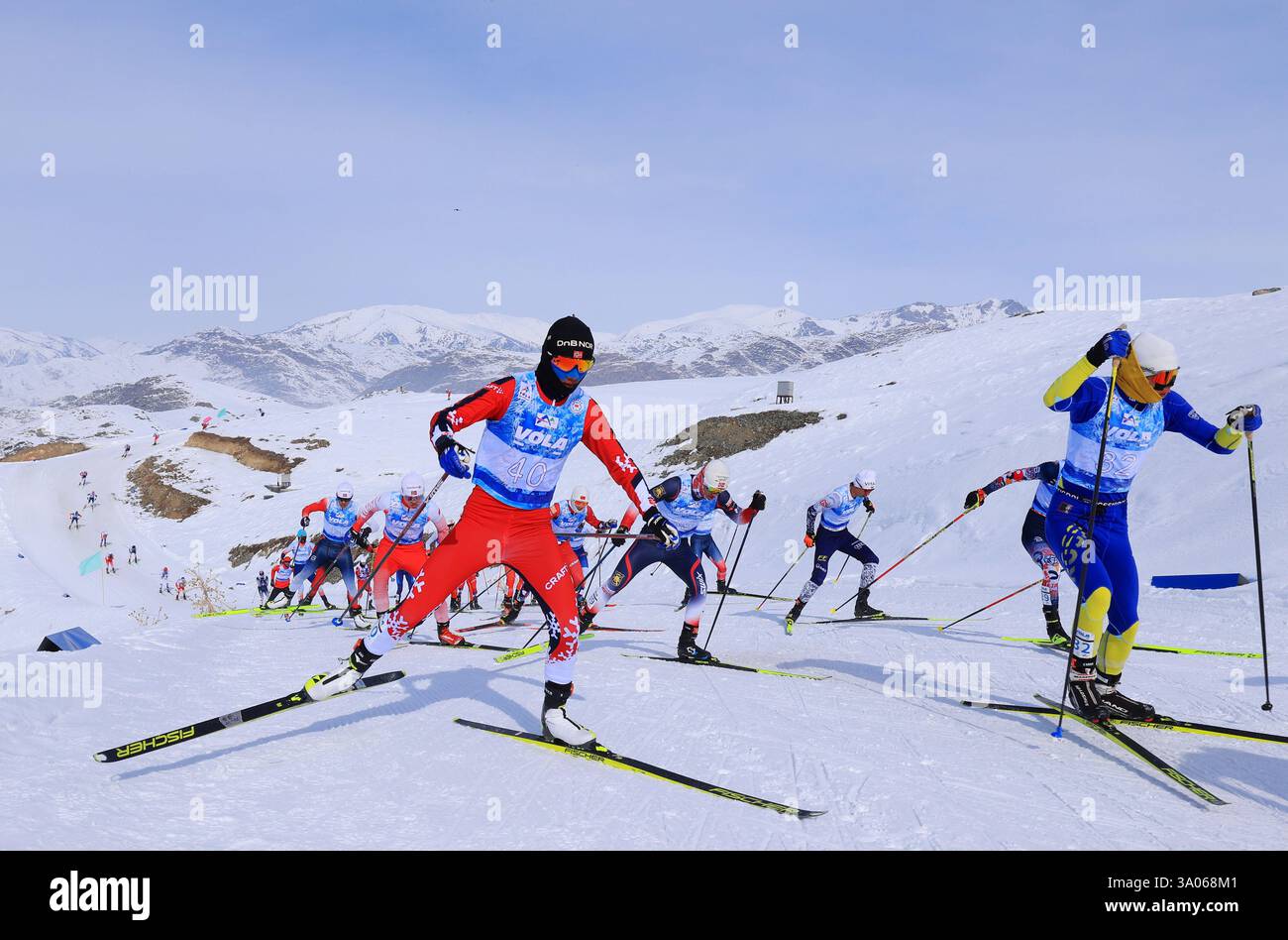 ALTAY, CHINA - MARCH 2, 2025 - Athletes chase on a cross-country ski ...