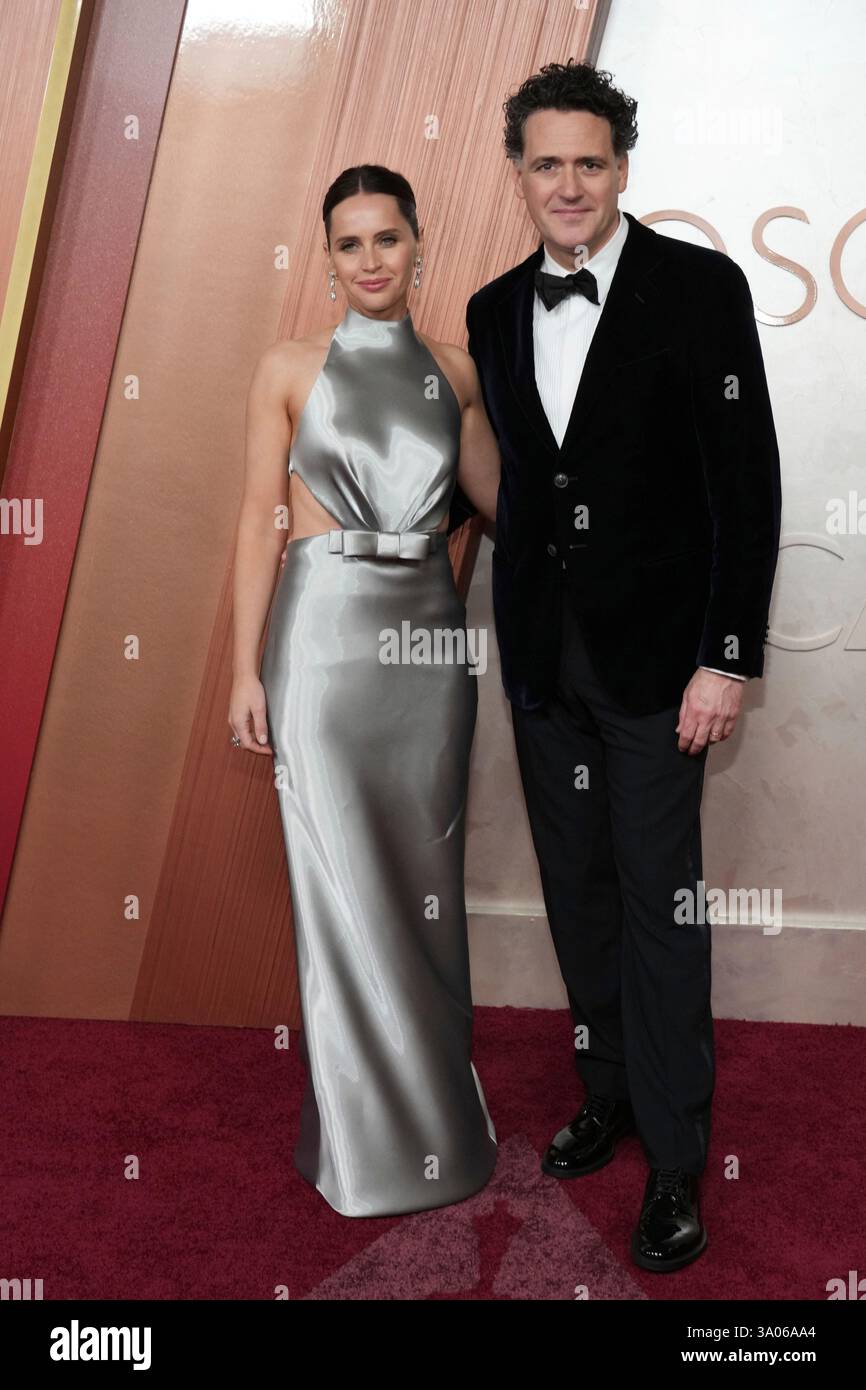 Felicity Jones, left, and Charles Guard arrive at the Oscars on Sunday ...