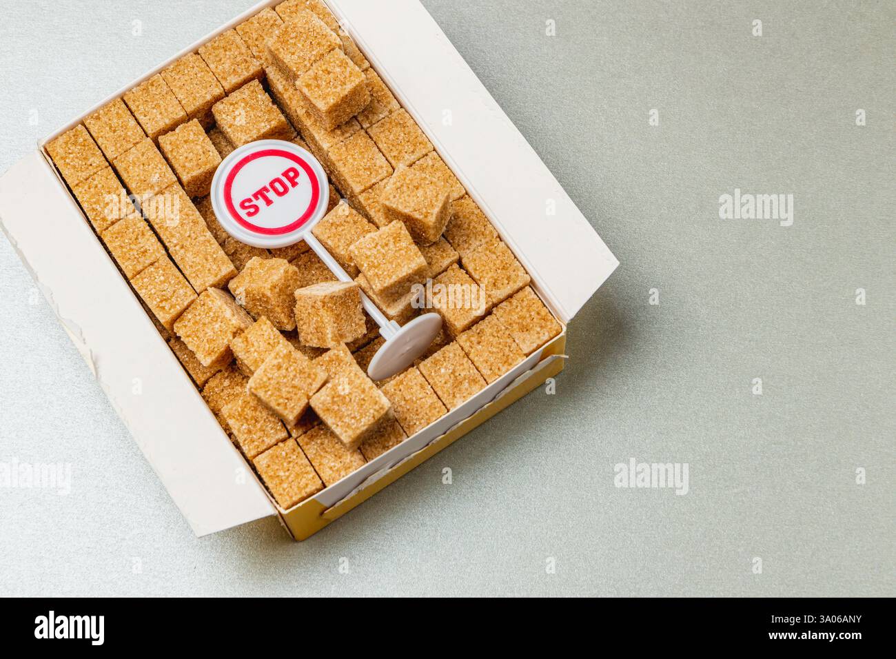 A box filled with brown sugar cubes features a prominent stop sign ...