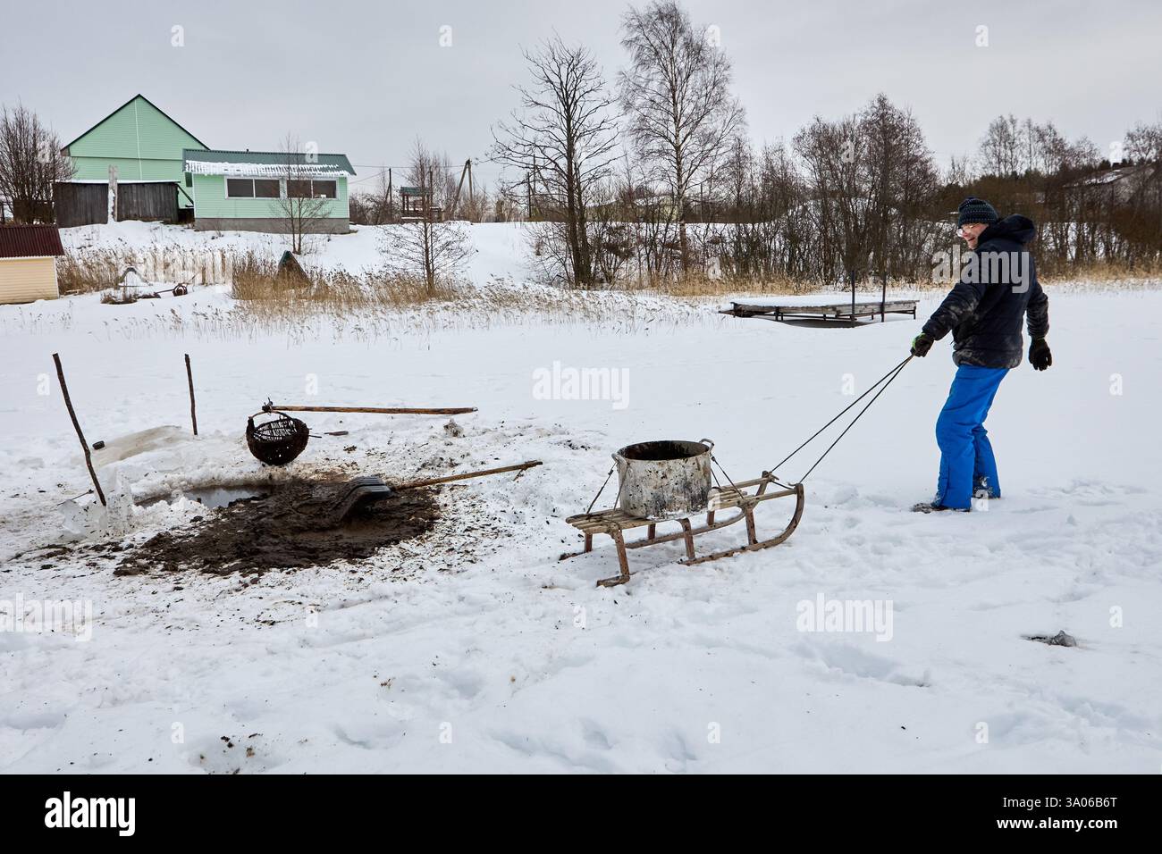 Farmer extracts sapropel sludge from freshwater lake through ice hole ...