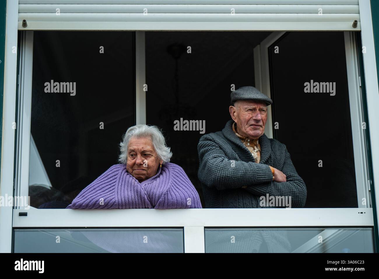 Elderly couple watching the Carnival celebration from their window ...