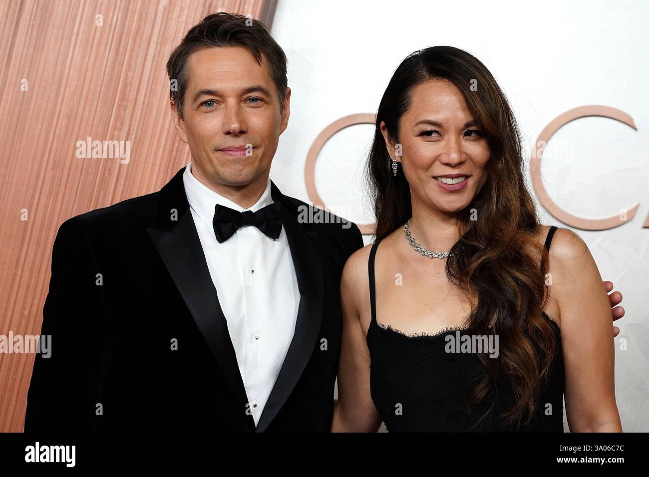 Sean Baker, left, and Samantha Quan arrive at the Oscars on Sunday ...
