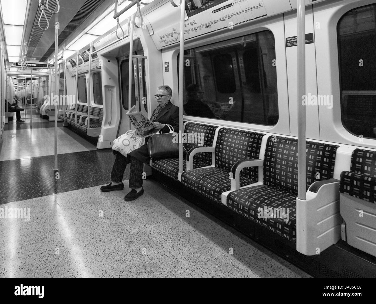 Passenger on the London Underground / London tube; lone passenger on an ...