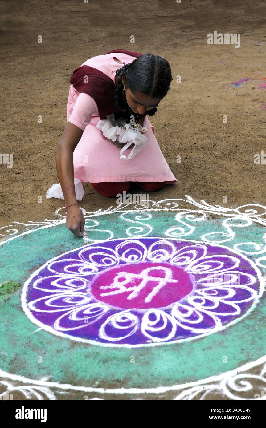 Girl making colourful rangoli at Kondhanpur, Pune, Maharashtra, India ...