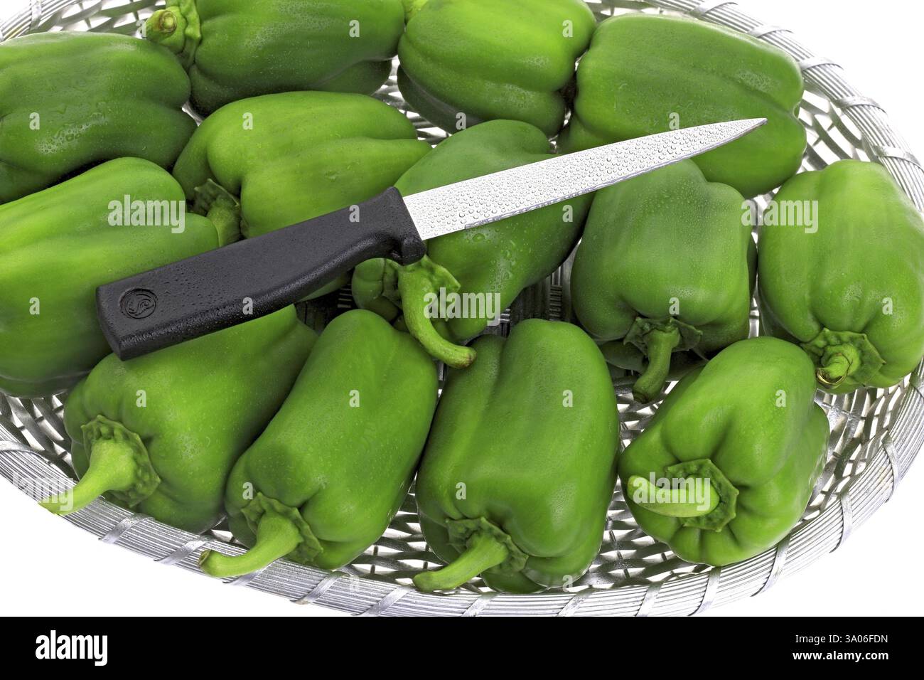 Green Capsicums Latin Capsicum Annuum in a basket with two Sharp knife ...