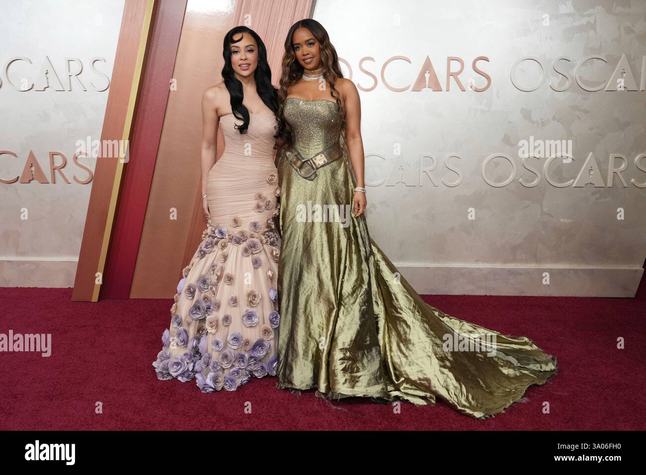Kristy Sarah Scott, left, and H.E.R arrive at the Oscars on Sunday ...