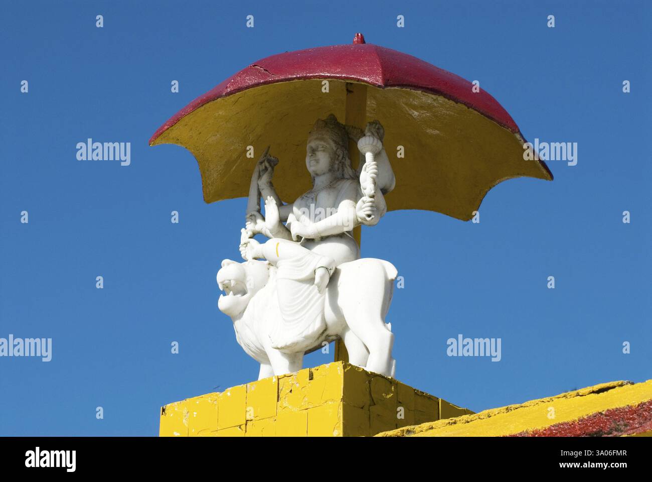 Statue or idol of devi seated on lion in marble stone at surkanda devi ...