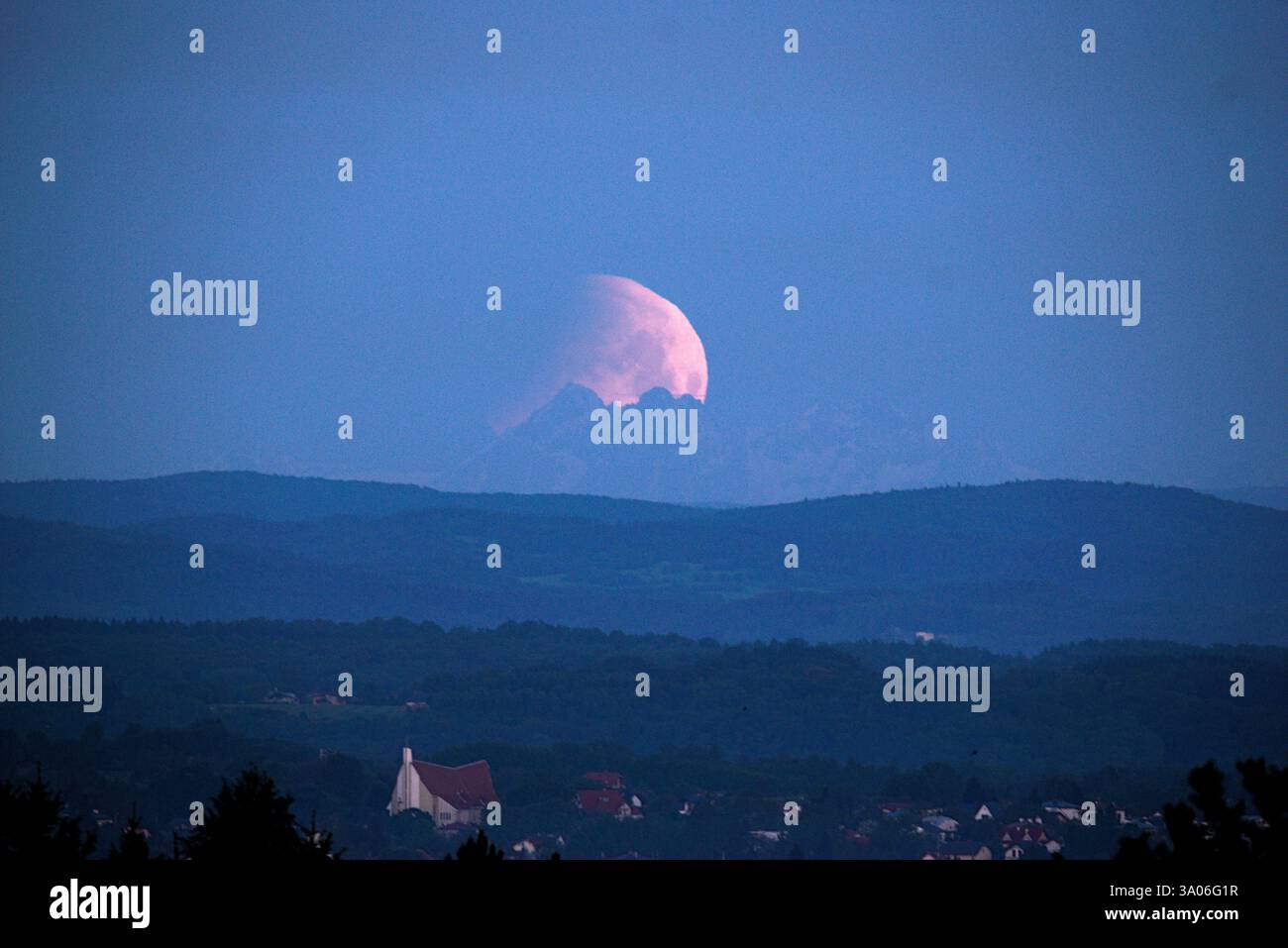 The partially eclipsed moon set above the Tatra Mountains as seen from ...
