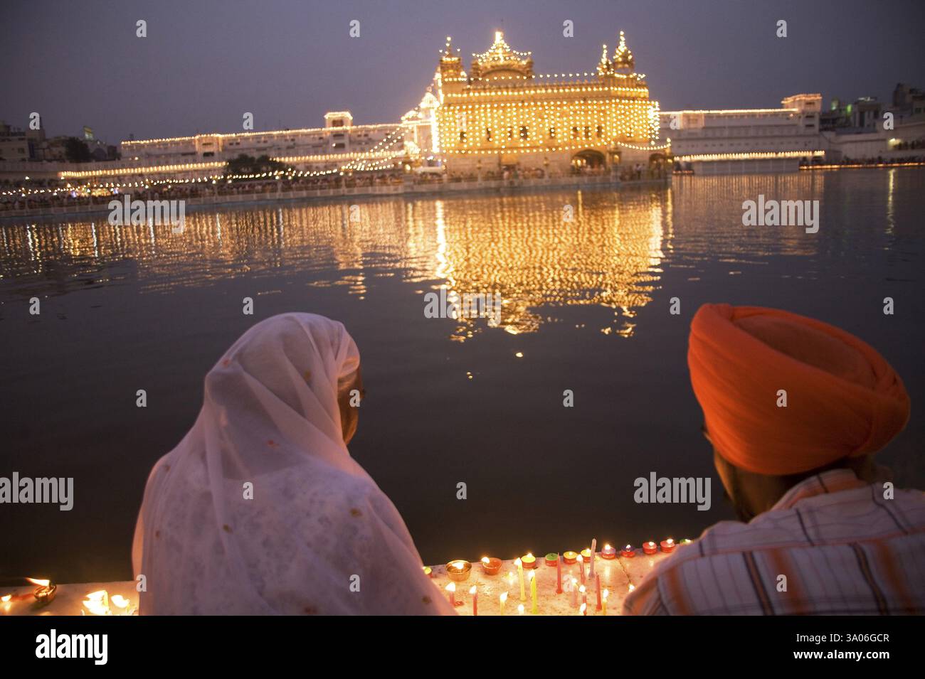 Sikh couple sitting holy water, Heri Mandir Sahib Dussera festival ...