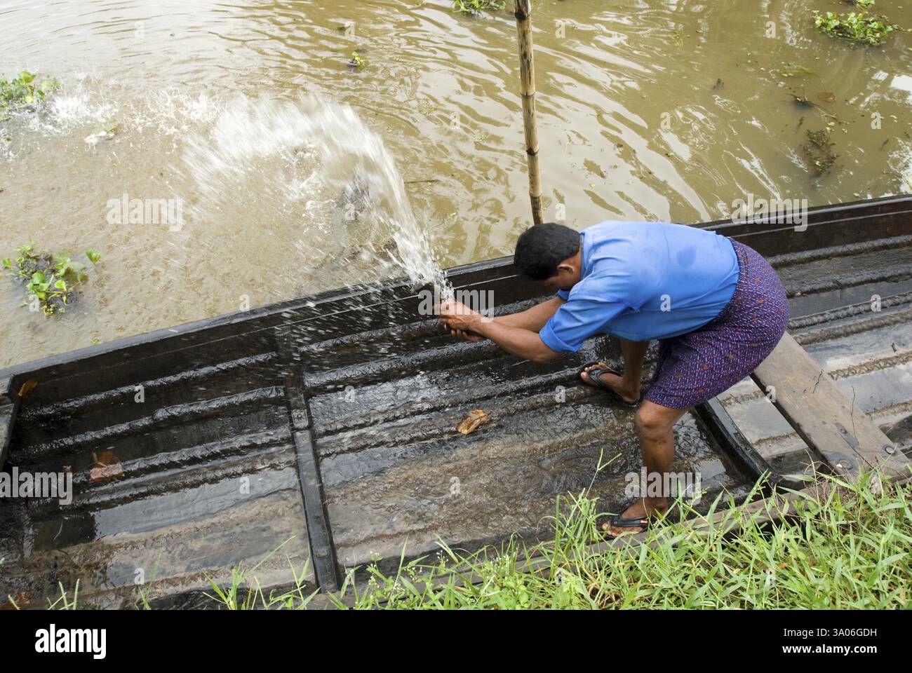 Boatman removing water from boat, Backwaters of Kerala, India, Asia ...