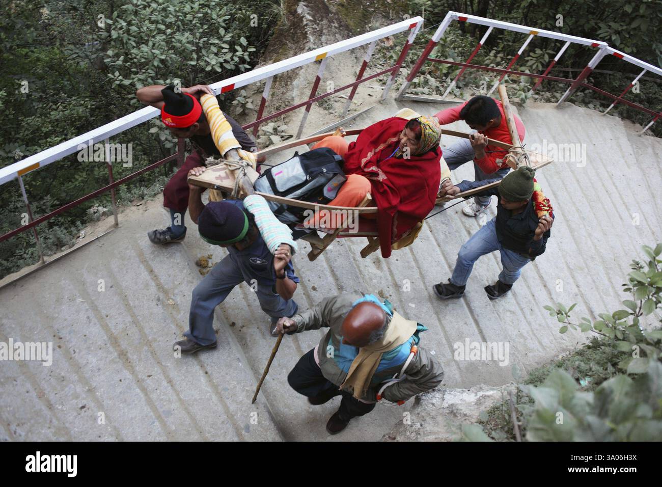 Woman carried in a palanquin to yamnotri temple at garhwal himalayas ...
