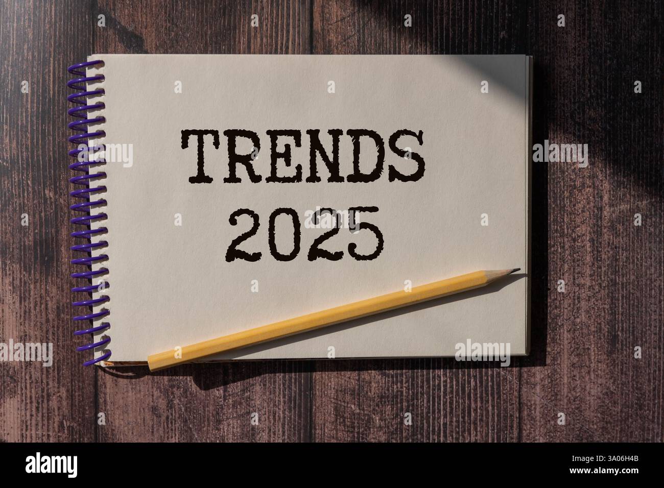 Miniature people and sticky note with text Trends 2025 on a red ...