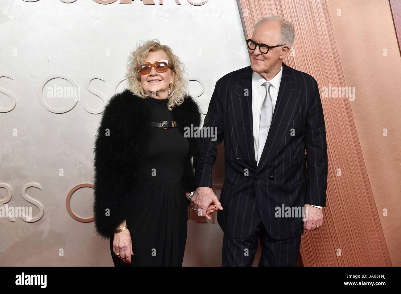 Mary Yeager, left, and John Lithgow arrive at the Oscars on Sunday ...