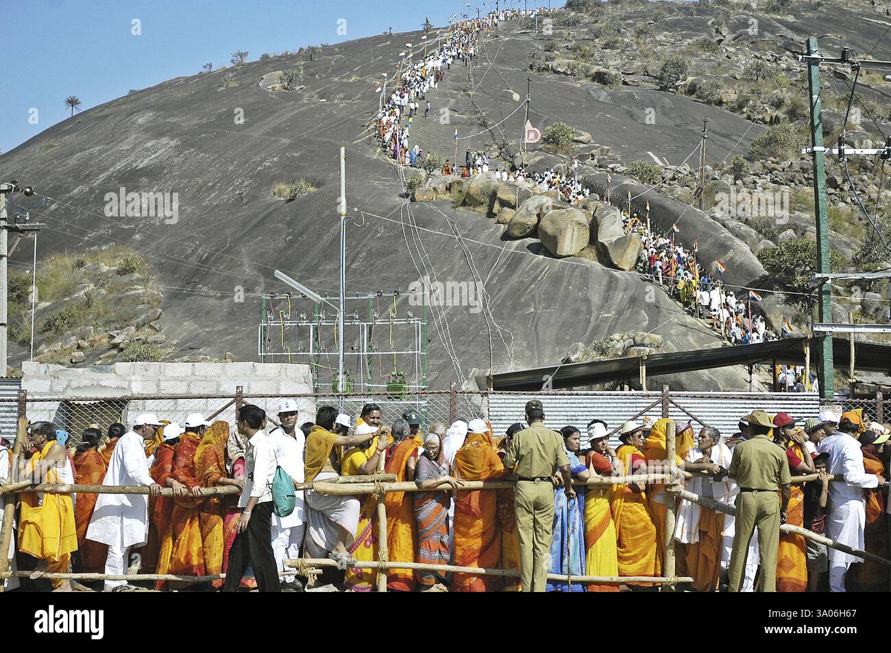 A huge crowd of pilgrims line up to go up to the holy statue of Lord ...