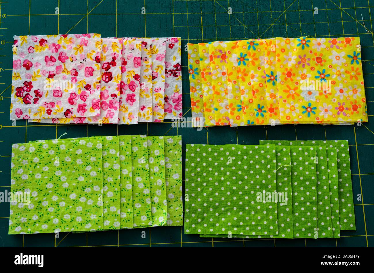 Above view of layered fabric squares for a quilt layering on cutting ...