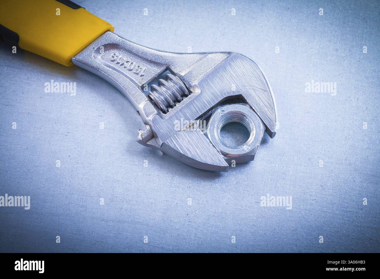 Adjustable tensioner and threaded screw nut on metallic background ...