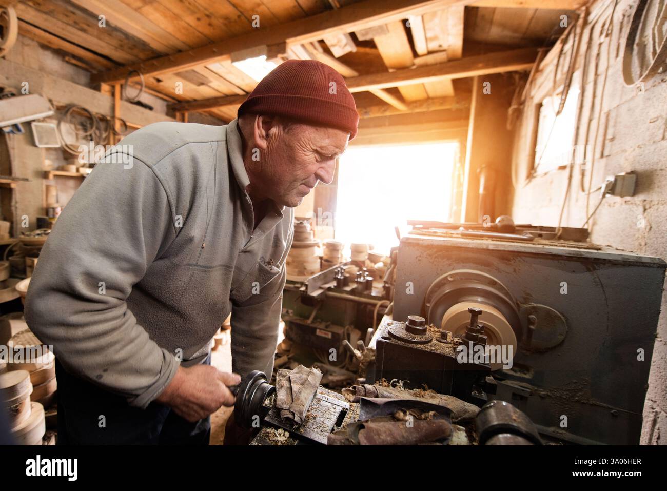 Elderly Craftsman Working in a Rustic Workshop Stock Photo - Alamy