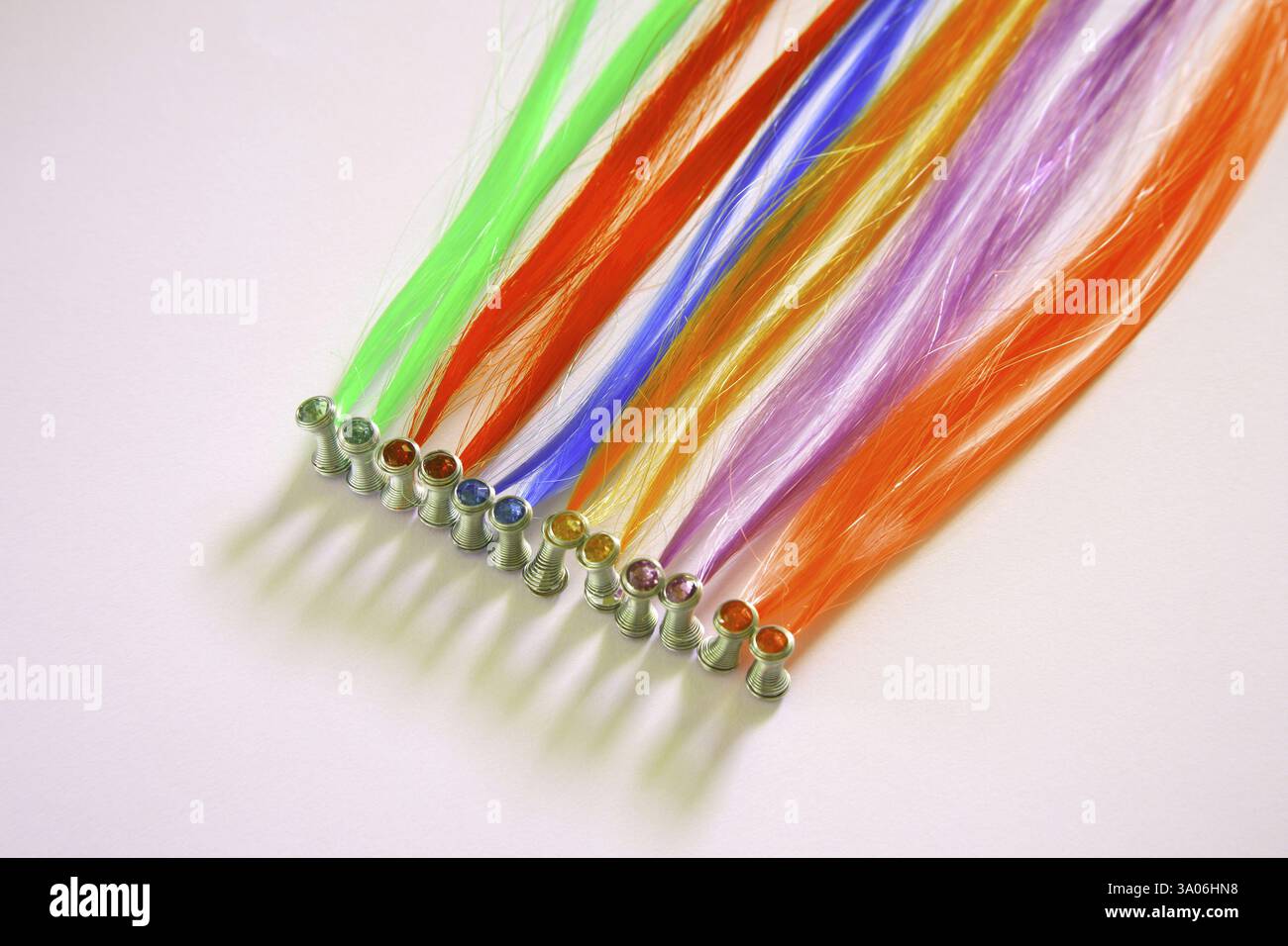 Artificial colourful hair made from soft plastic on white background ...