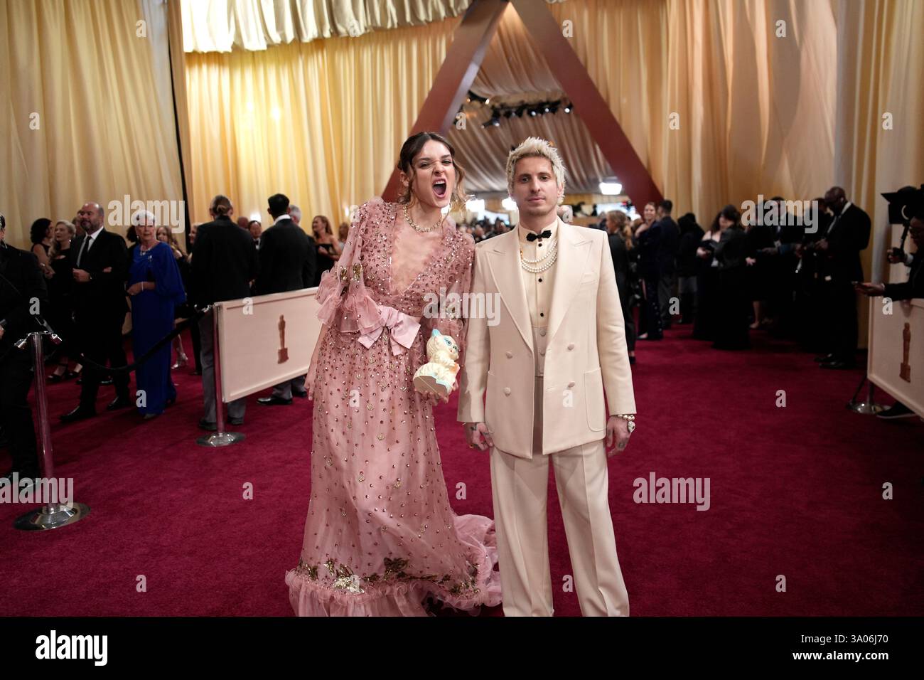 Charlotte Lawrence, left, and Andrew Watt arrive at the Oscars on ...