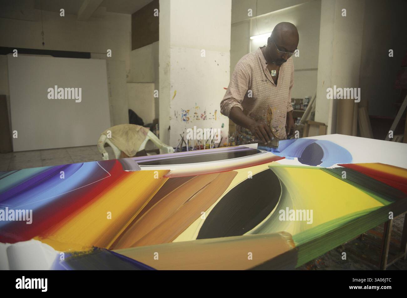 Indian contemporary artist Bose Krishnamachari in his studio working on ...