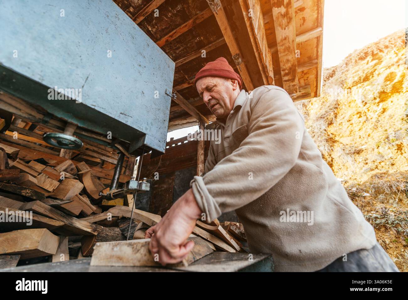Carpenter Cutting Wood with a Bandsaw in a Rustic Workshop Stock Photo ...