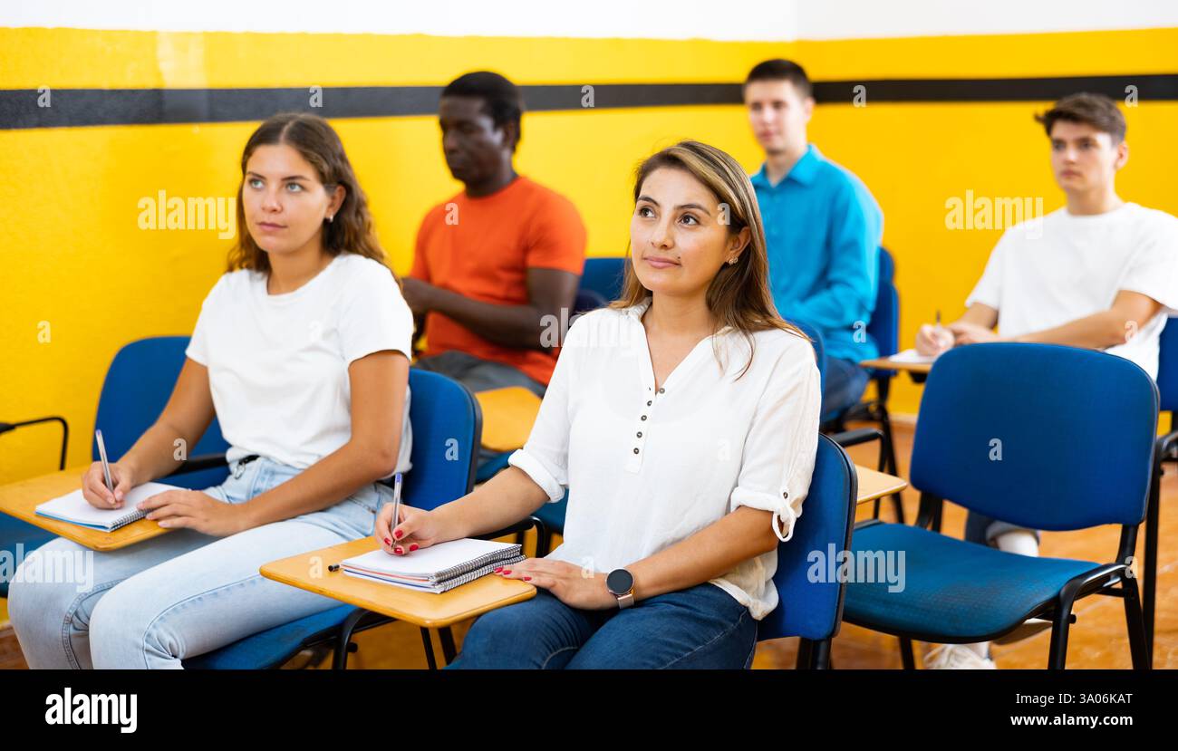 Women and men attending lecture in taxi training school Stock Photo - Alamy