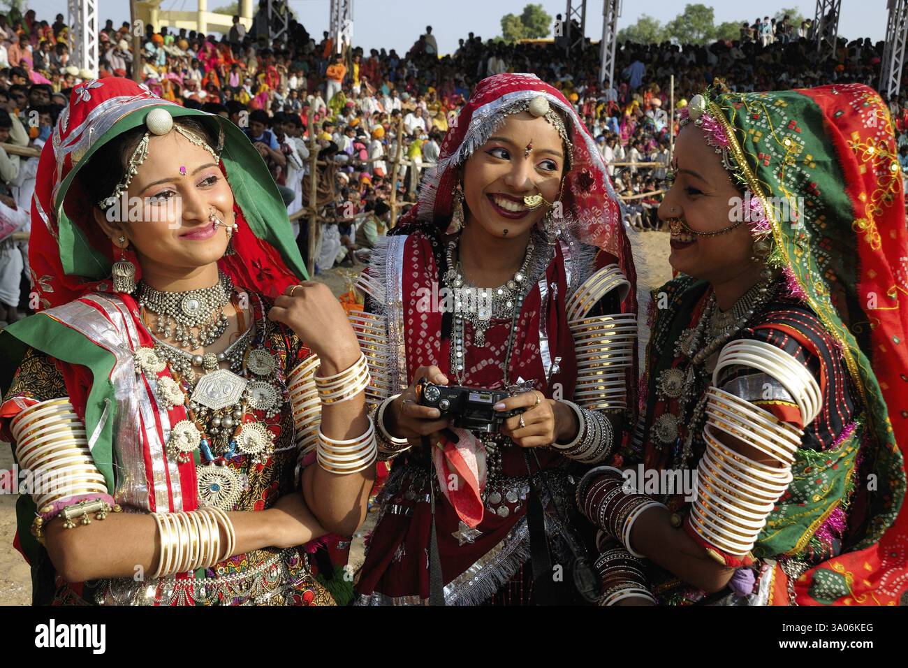 Girls in traditional jewellery and rajasthani costume having chat with ...