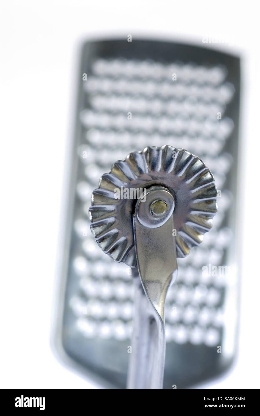 Stainless steel kitchen utensil cutter wheel with grater on white ...
