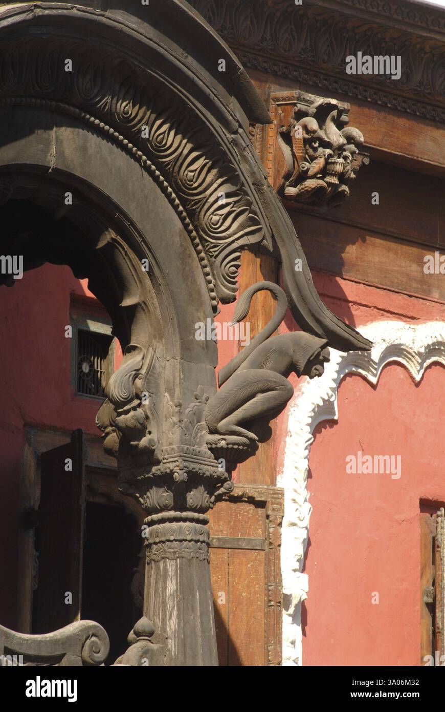 Wood carved pillar with monkey and floral design at entrance of ...
