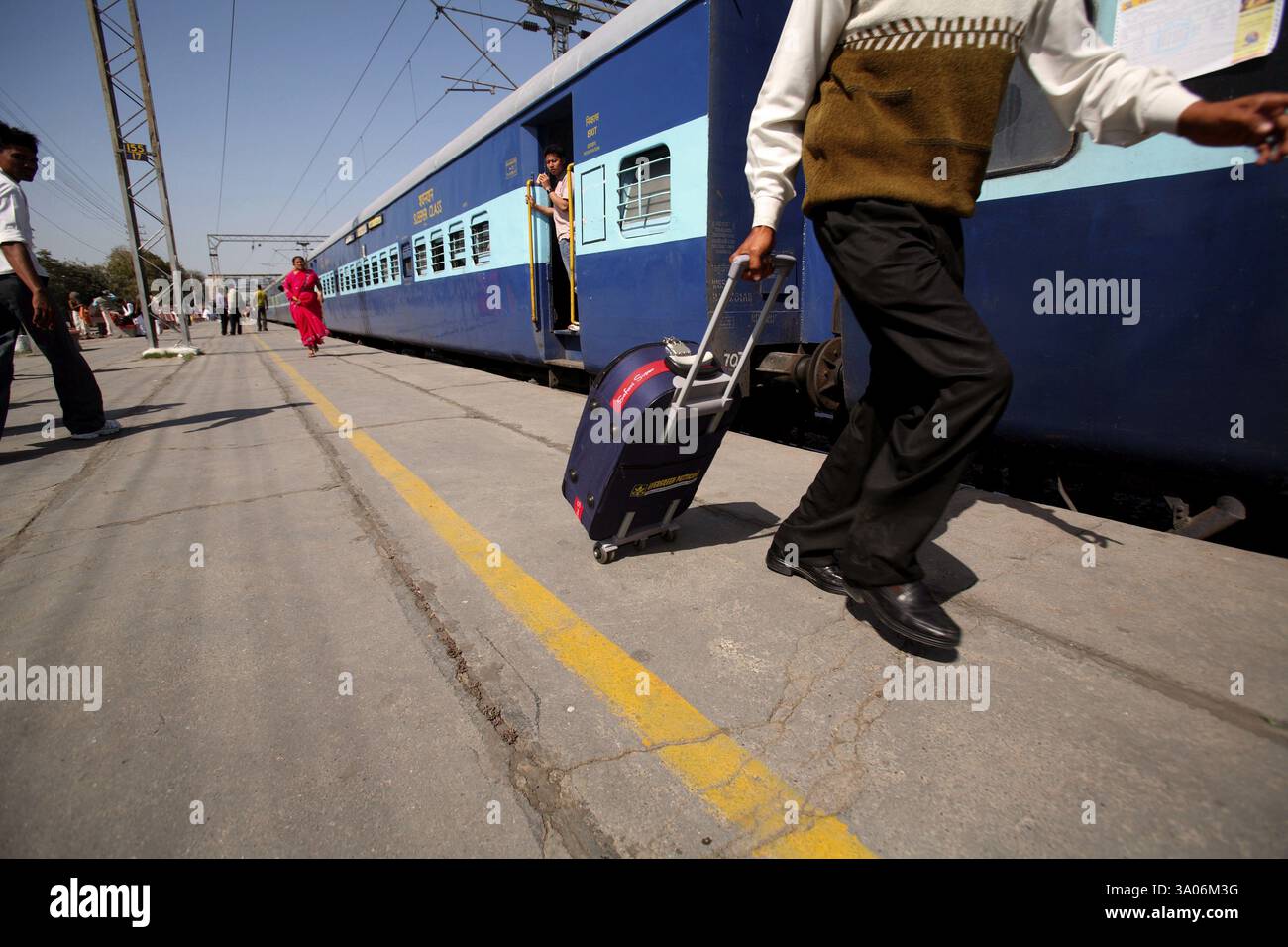 Passenger with trolley bag at railway station in India Stock Photo - Alamy