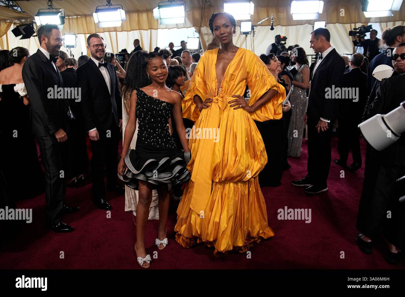 Liyabona Mroqoza, left, and Avumile Qongqo arrive at the Oscars on ...