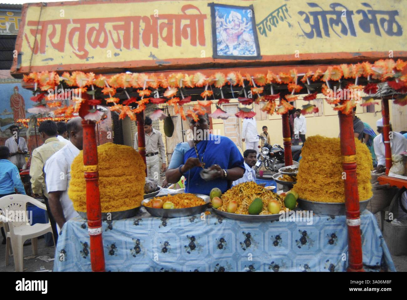 A woman sells Poha Chivda crispy beaten rice flavoured with peanuts or ...