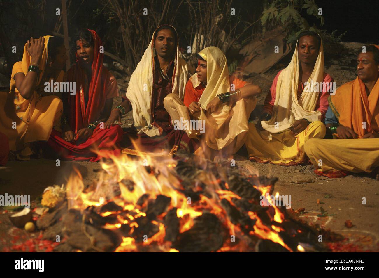 Eunuchs sitting around burning pyre during wedding of eunuchs on ...