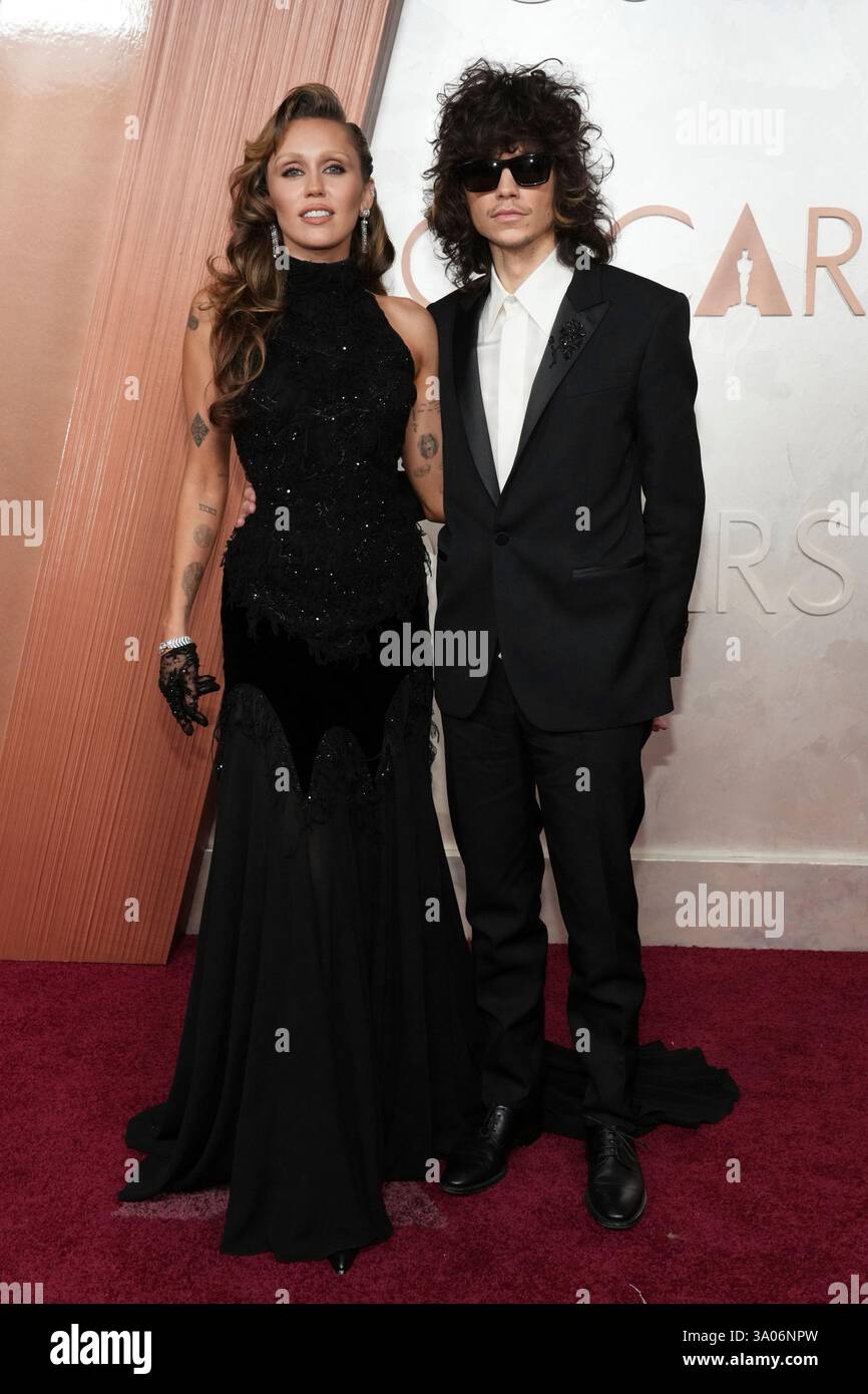 Miley Cyrus, left, and Maxx Morando arrive at the Oscars on Sunday ...