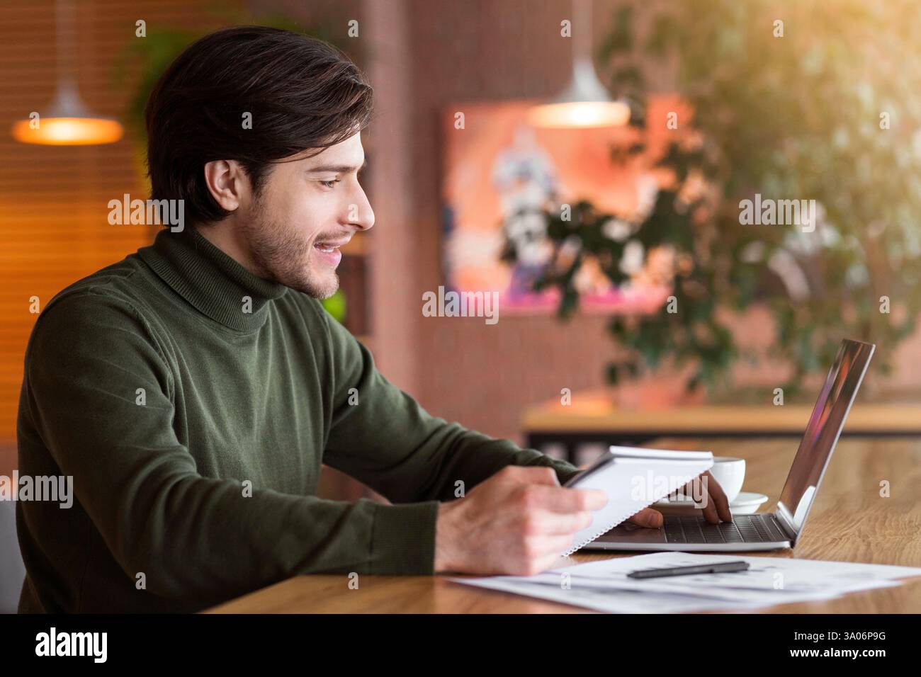 Journalist working on new article online at cafe Stock Photo - Alamy